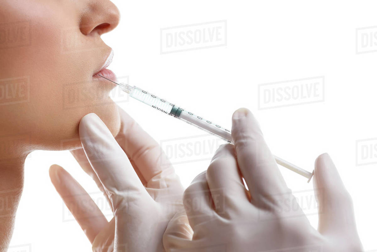 Portrait of attractive woman getting injection isolated on white ...