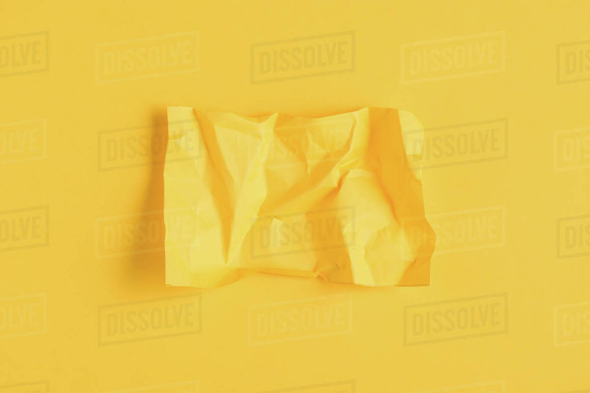 crumpled paper on yellow background with copy space - Stock Photo ...