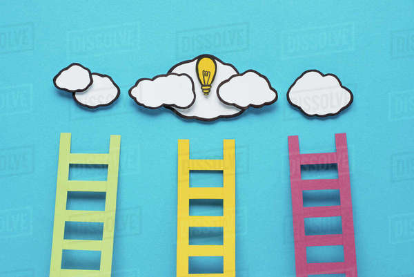 top view of cardboard ladders with light bulb and clouds on blue ...