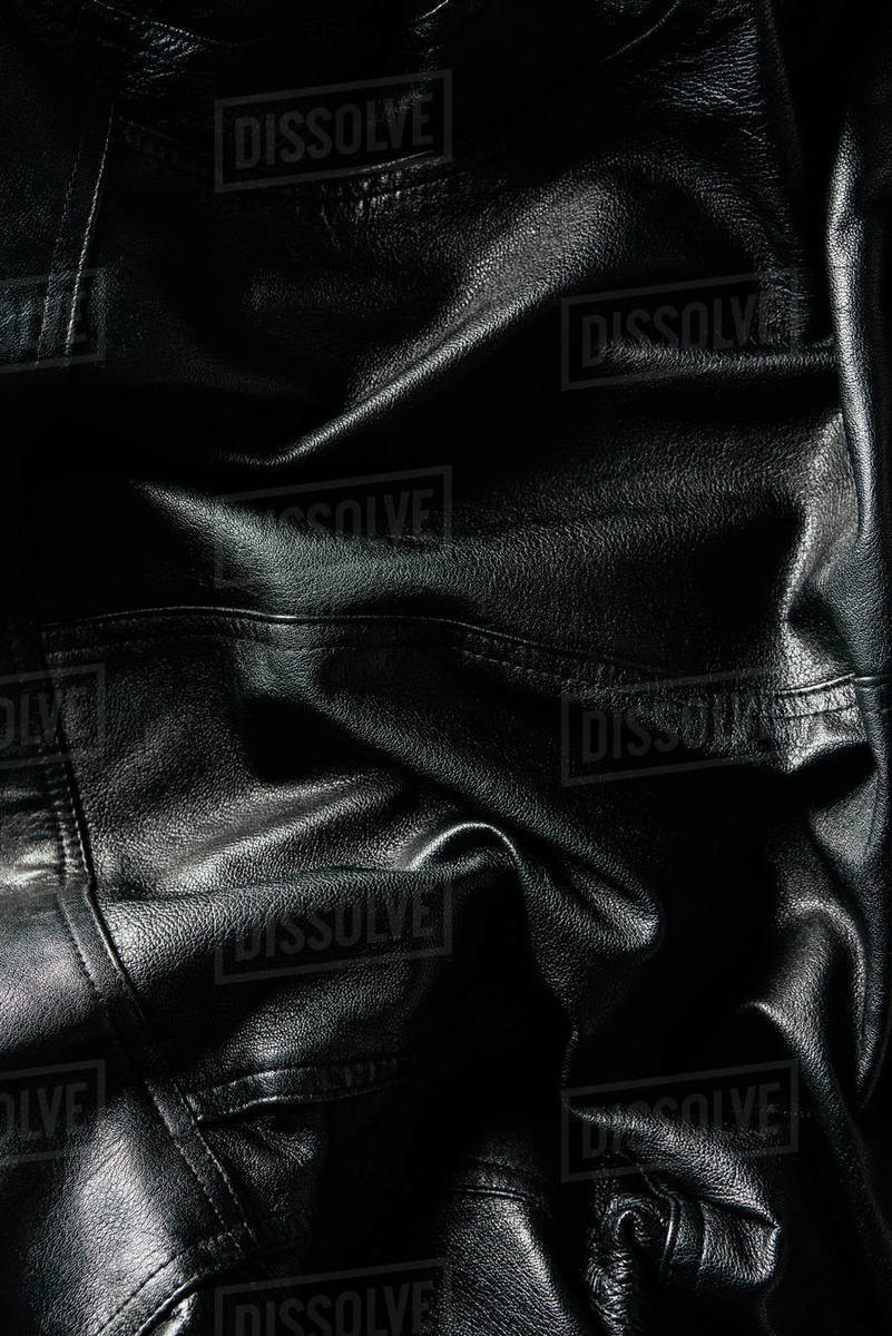 Full frame of black leather jacket as background - Stock Photo - Dissolve