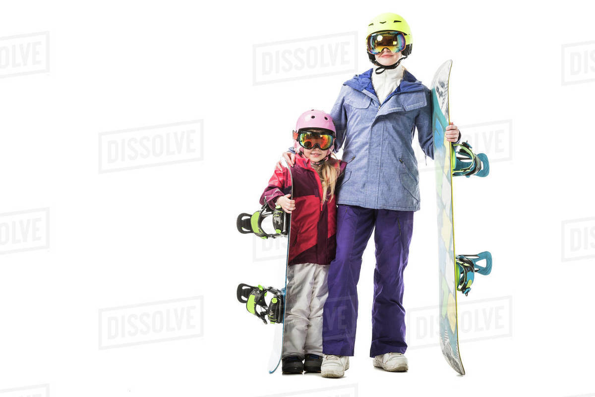 Mom and preschooler daughter in ski suits, goggles and helmets with ...