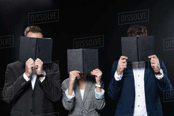 Group of business people covering faces with notebooks isolated on ...