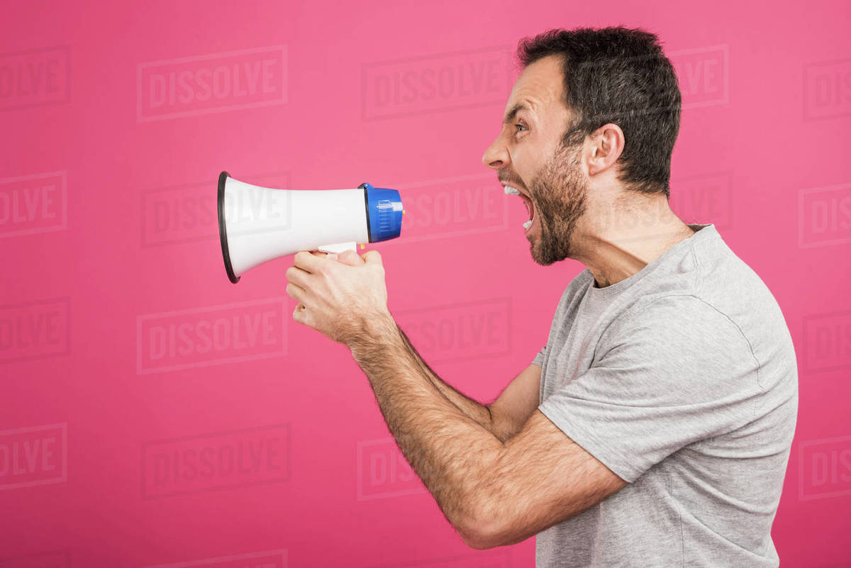 Aggressive man shouting with megaphone, isolated on pink - Royalty-free ...