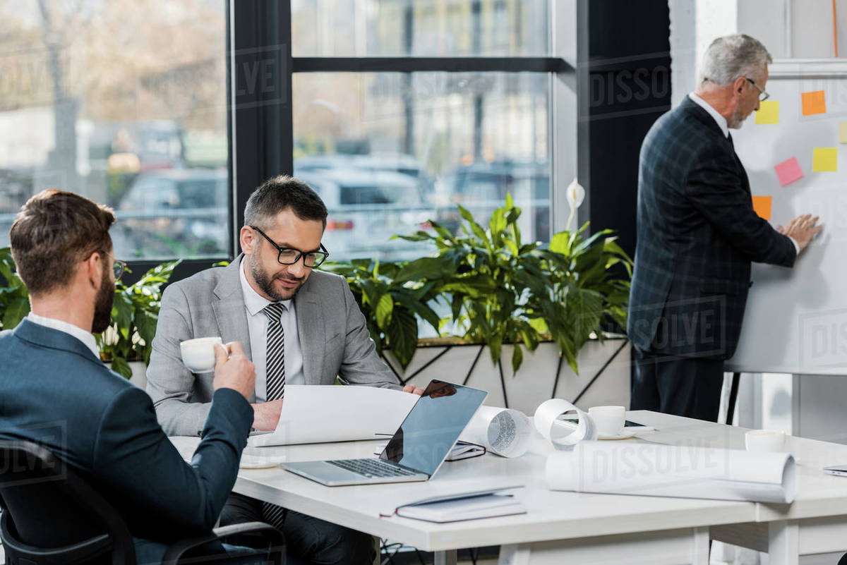 Handsome businessmen in suits working in office - Royalty-free Stock ...