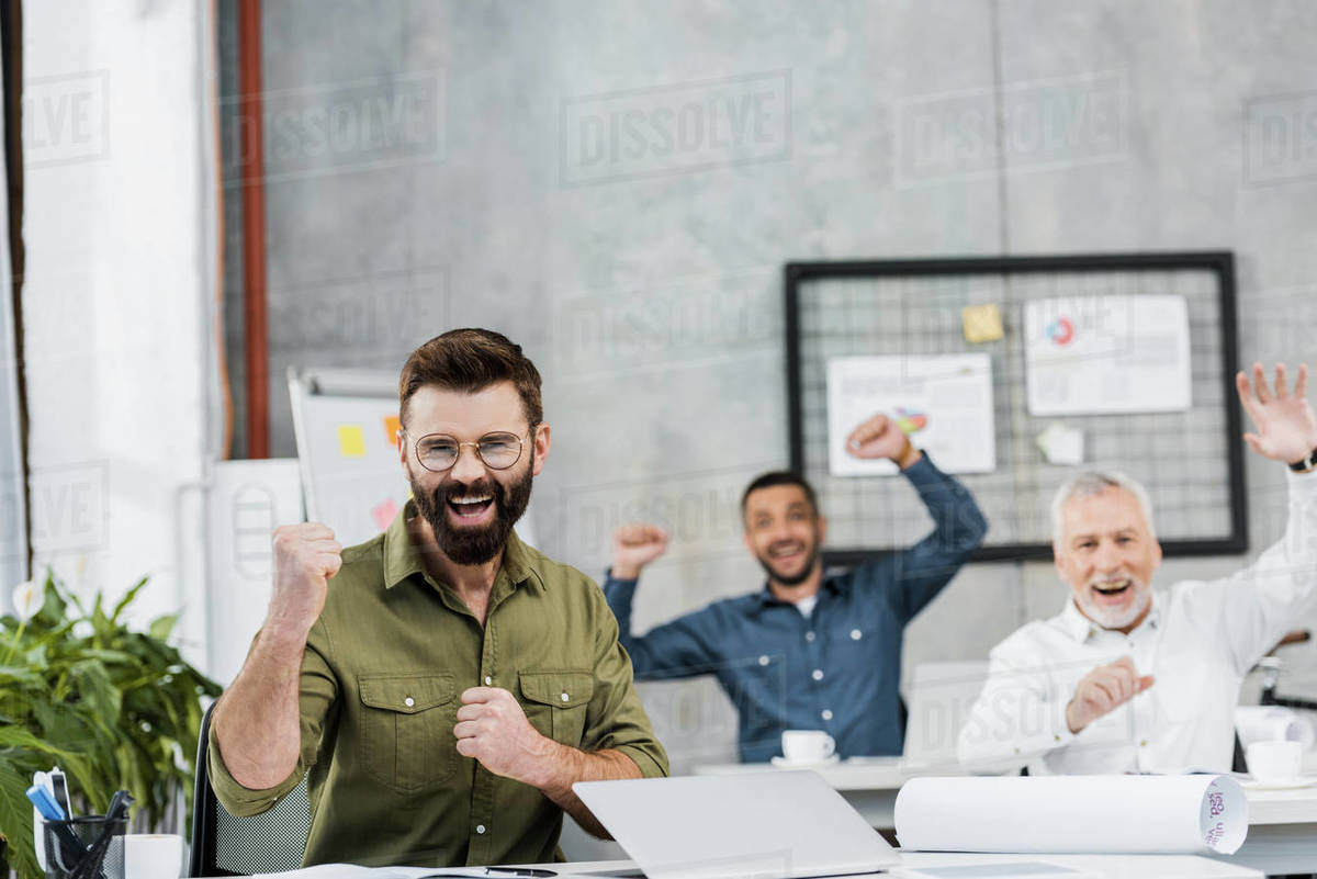 Happy handsome businessmen showing yes gesture in office - Royalty-free ...