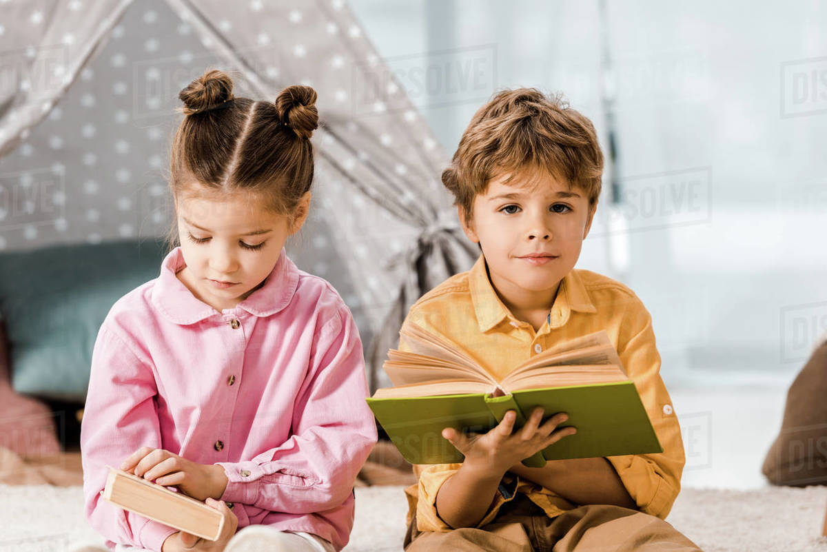 Adorable little children reading books together - Royalty-free Stock ...