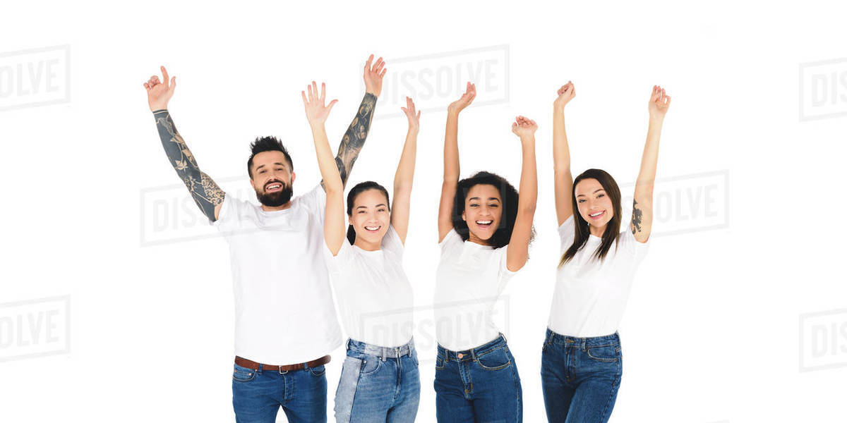 Multicultural group of friends raising hands in air and smiling ...