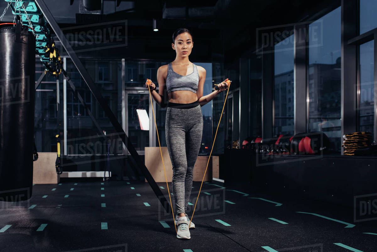 Athletic girl exercising with jump rope at gym - Royalty-free Stock ...
