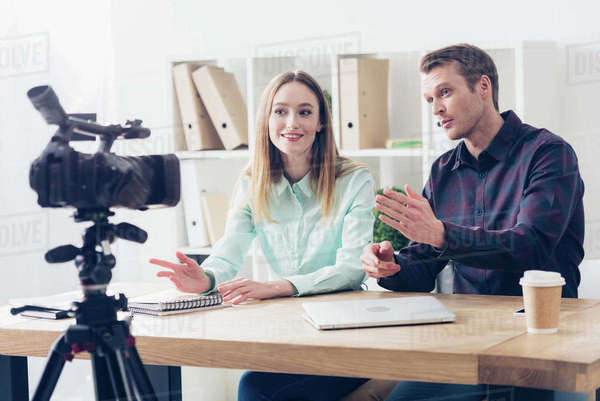 Smiling colleagues recording vlog in office - Royalty-free Stock Photo ...
