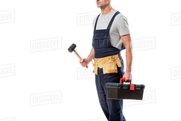 Cropped view of construction worker holding hammer and tool box ...