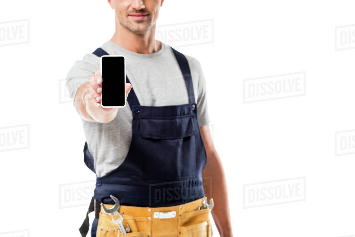 Cropped view of worker holding smartphone with blank screen isolated on ...