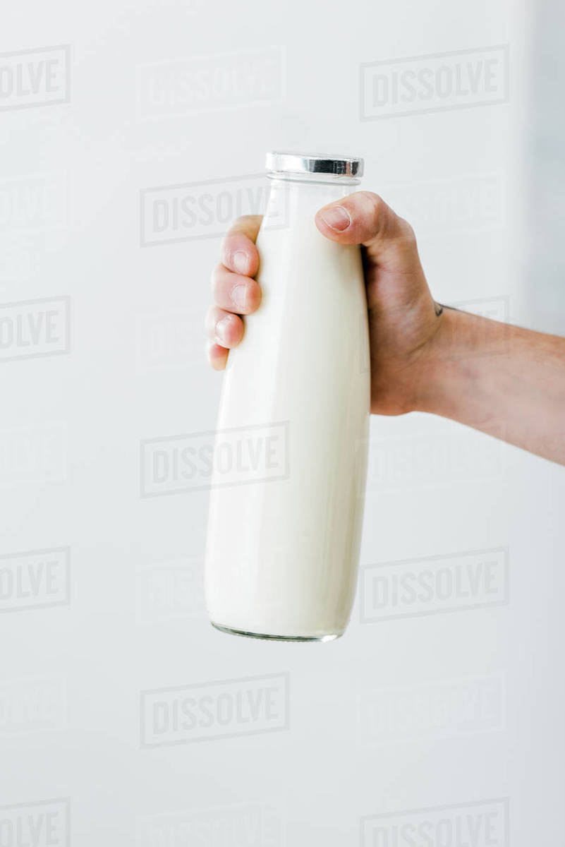 Cropped view of male hand holding milk bottle - Royalty-free Stock ...