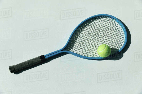 Tennis racket and ball on the floor at room with daylight - Royalty ...