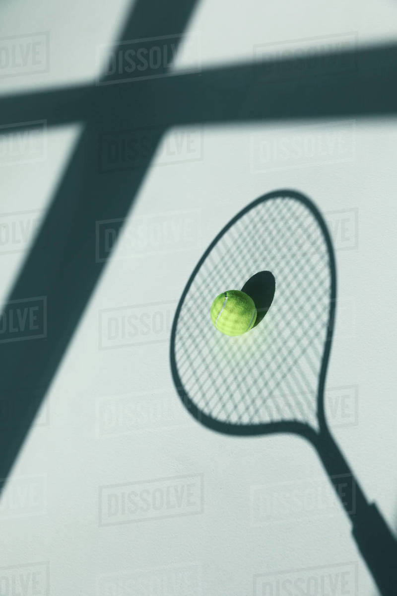 Tennis racket and ball on the floor at room with daylight - Royalty ...