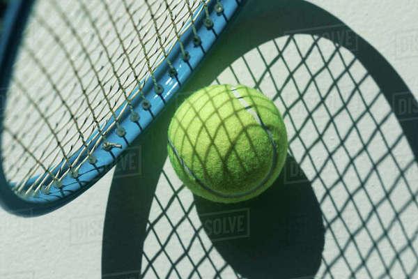 Tennis racket and ball on the floor at room with daylight - Royalty ...