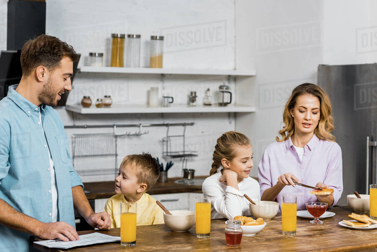 Happy family having breakfast at table in kitchen - Royalty-free Stock ...