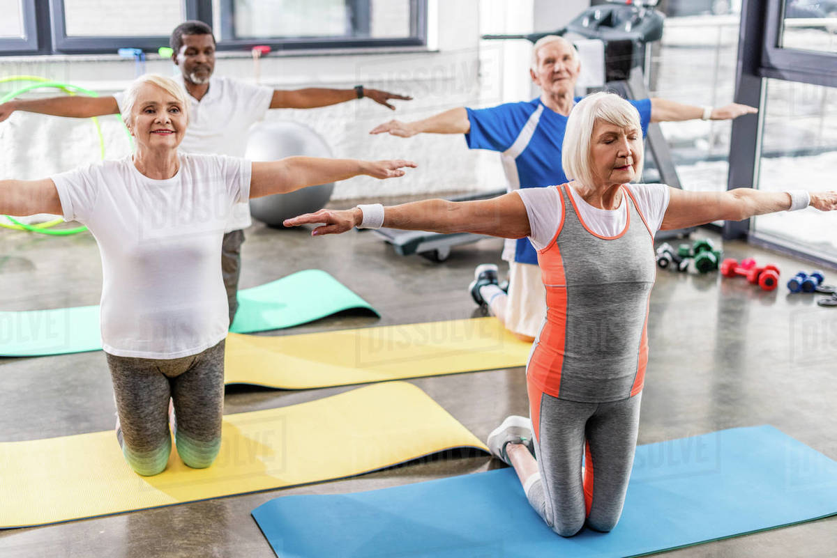 Selective focus of senior multicultural sportspeople synchronous ...