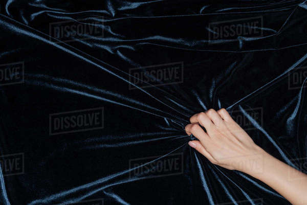 Cropped view of female hand tightly holding dark velvet cloth - Royalty ...