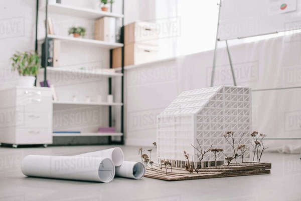 Modern architect office design with blueprints and house model on ...