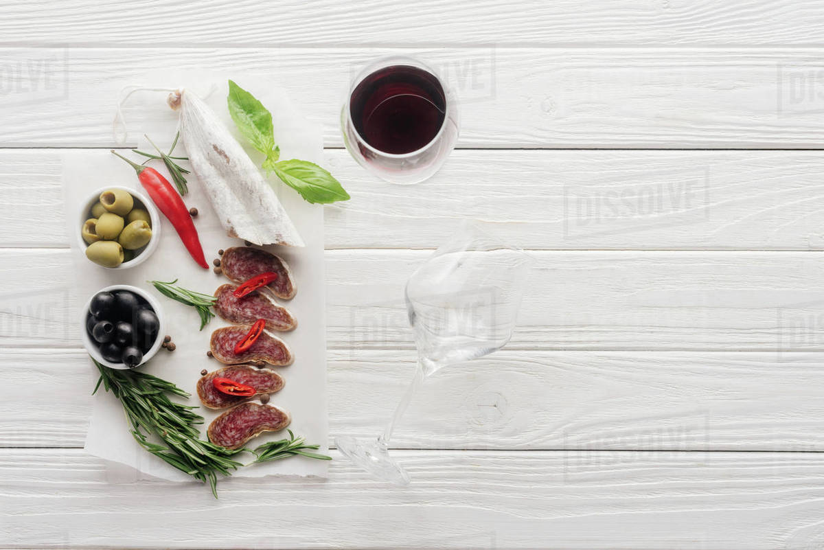 Food composition with glass of red wine and assorted meat snacks on ...