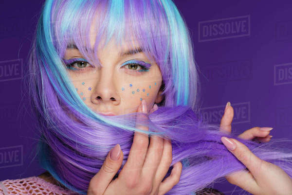 Attractive sensual girl posing in violet wig with stars on face ...