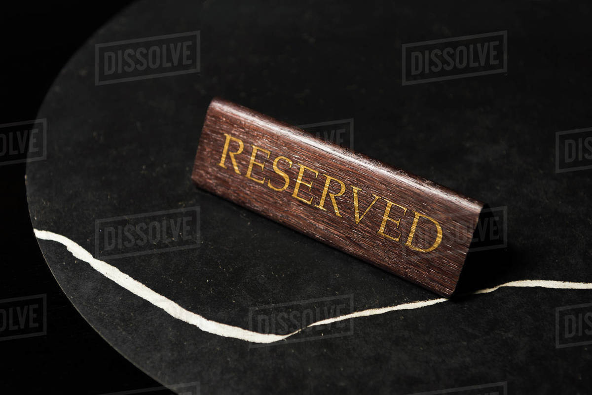 Reserved sign on black table in cafe with copy space - Stock Photo ...