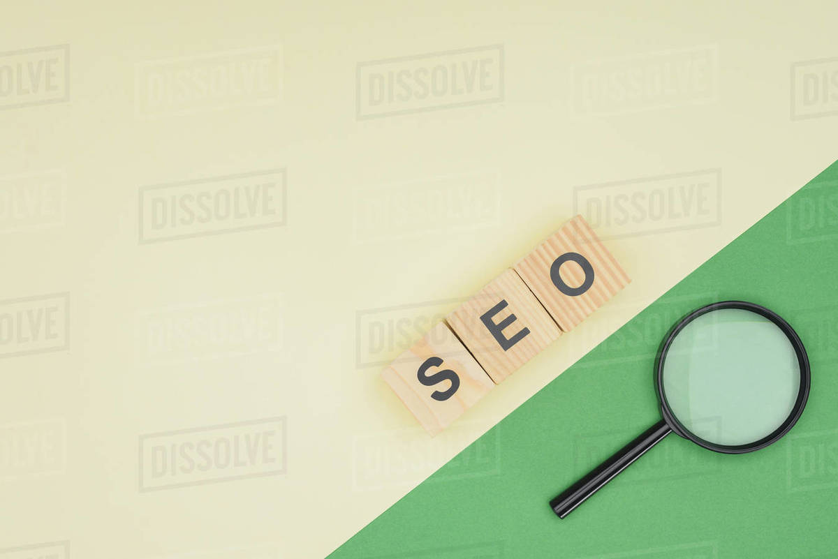 Top view of wooden cubes with seo lettering and magnifier glass - Stock ...