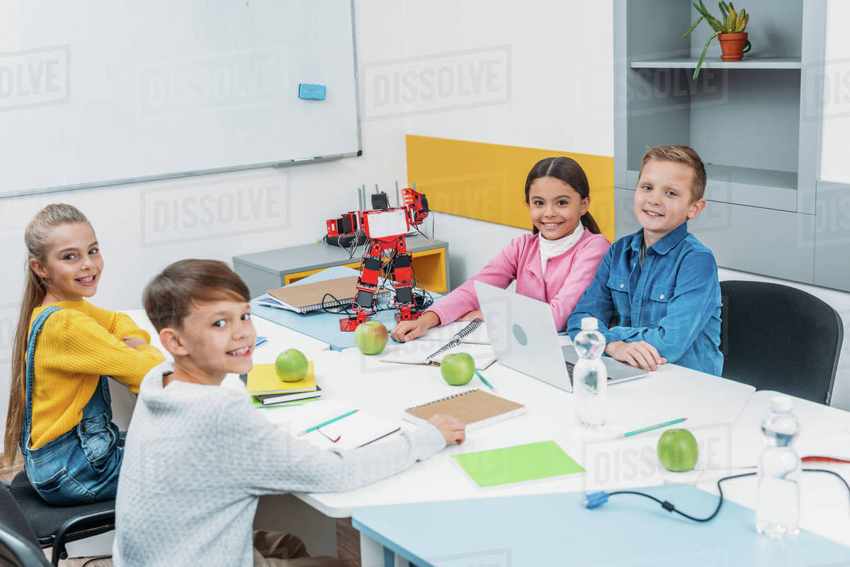 Joyful children looking at camera at stem robotics lesson - Stock Photo ...