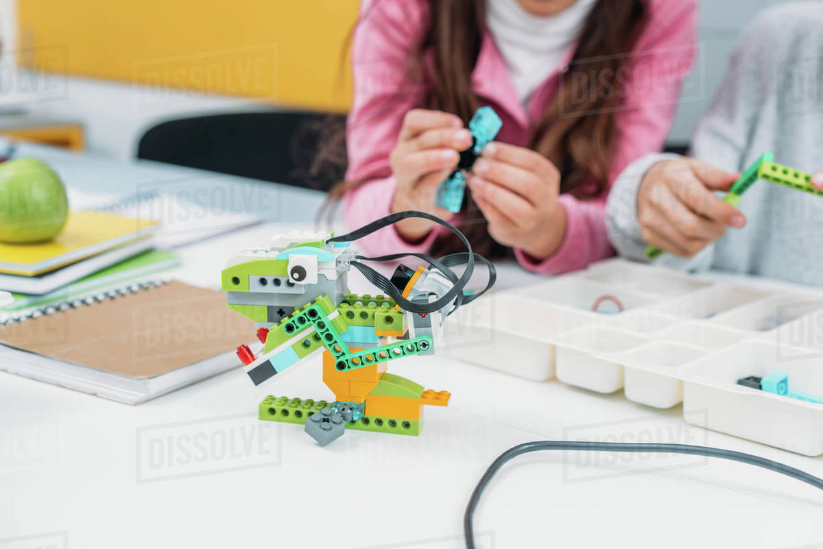 Cropped view of classmates working together on project during stem ...