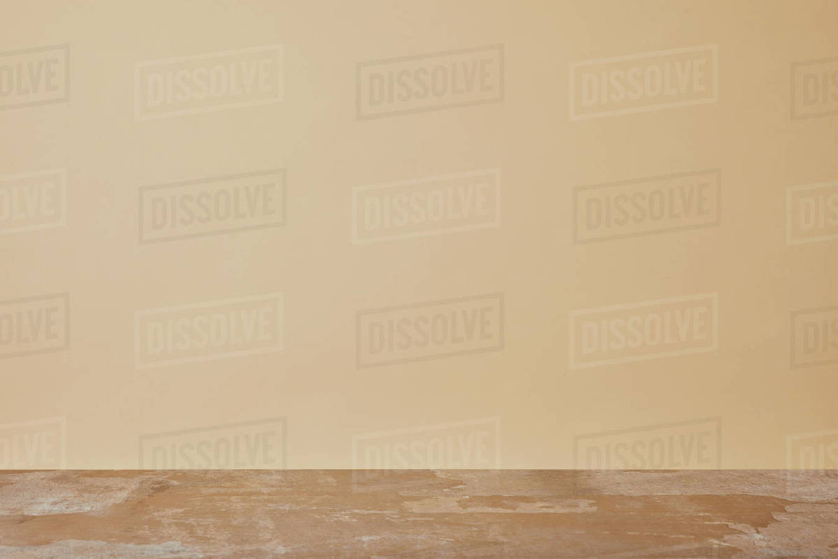 Dusty wooden table isolated on beige background - Stock Photo - Dissolve