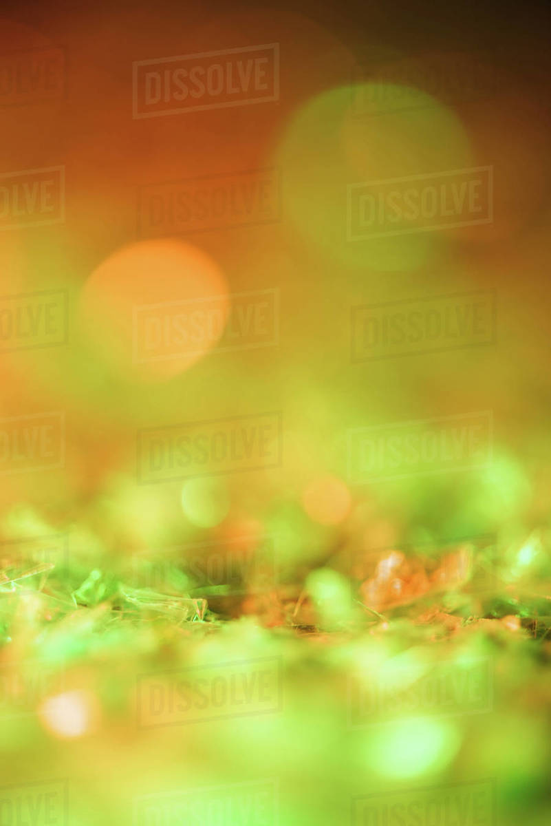 Glowing background with orange and green glitter with bokeh - Stock ...