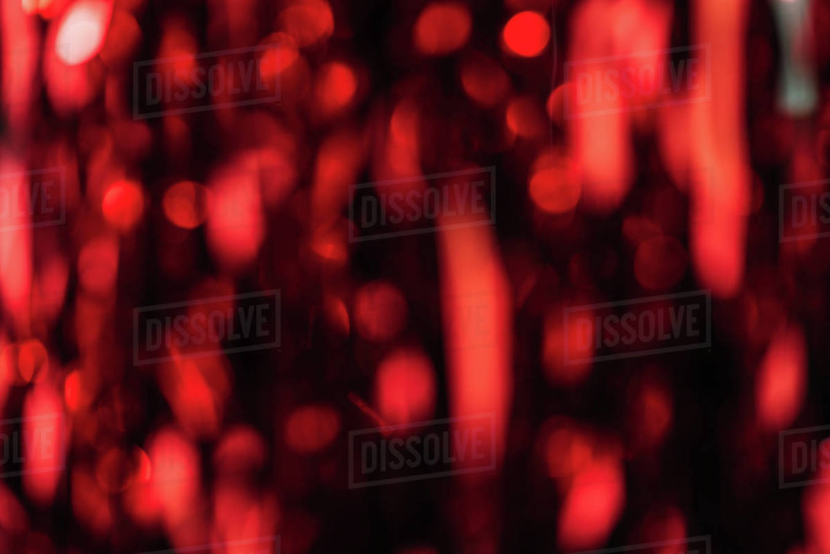 Dark red blurred streamers as christmas background - Stock Photo - Dissolve