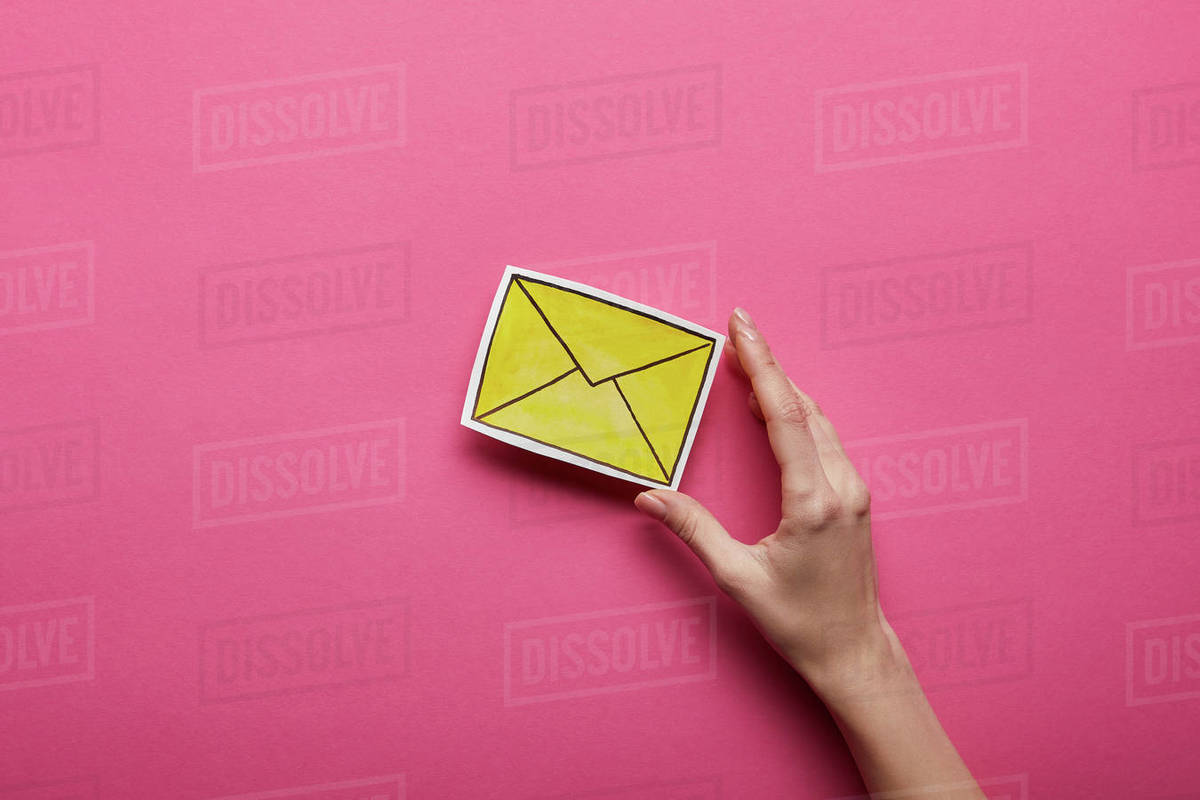 Top view of hand holding yellow message sign on pink background - Stock ...