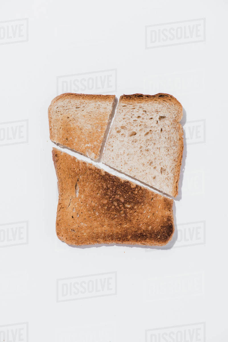 Top view of slice of bread with roasted pieces on white surface - Stock ...