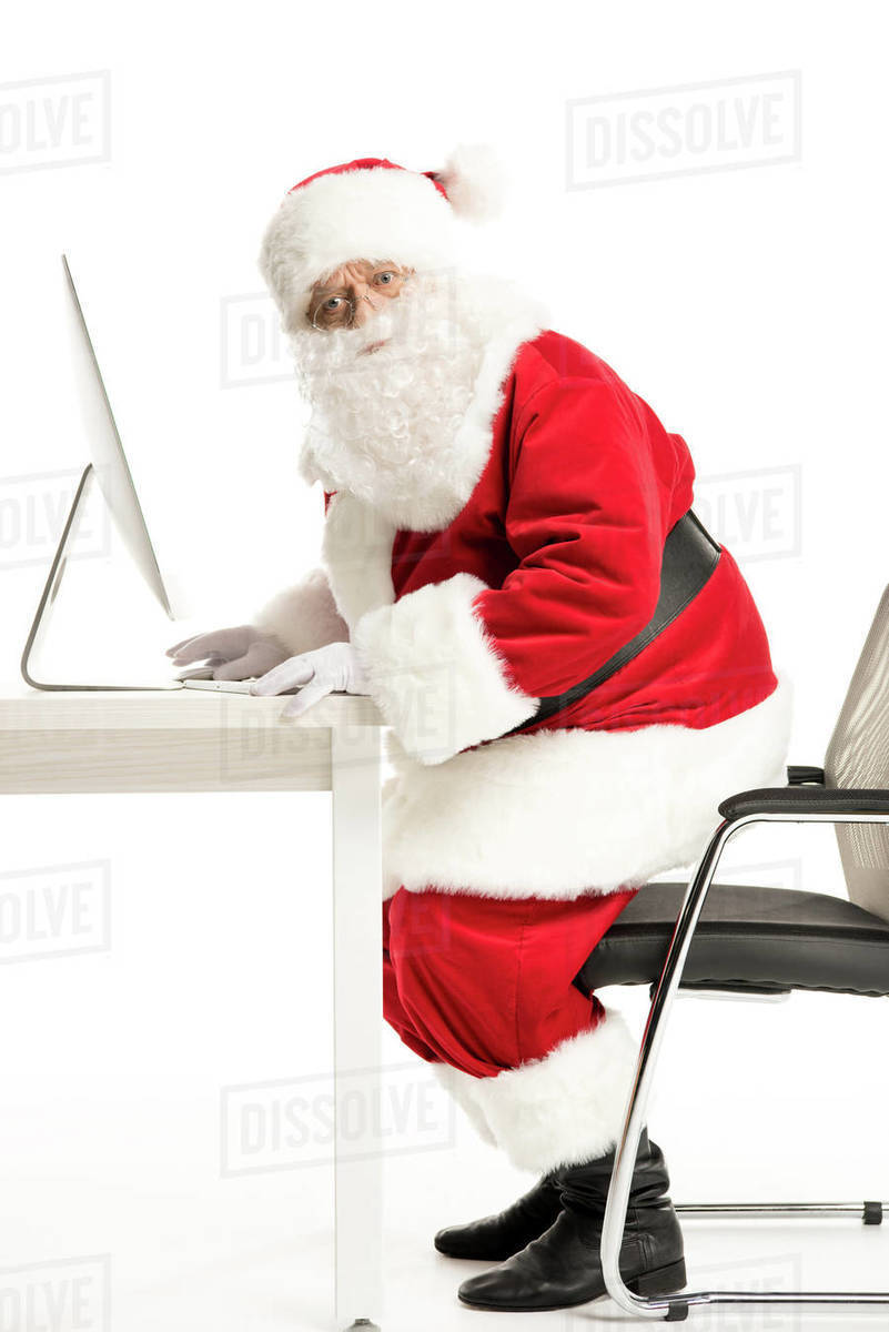 Side view of Santa Claus using computer isolated on white - Stock Photo ...