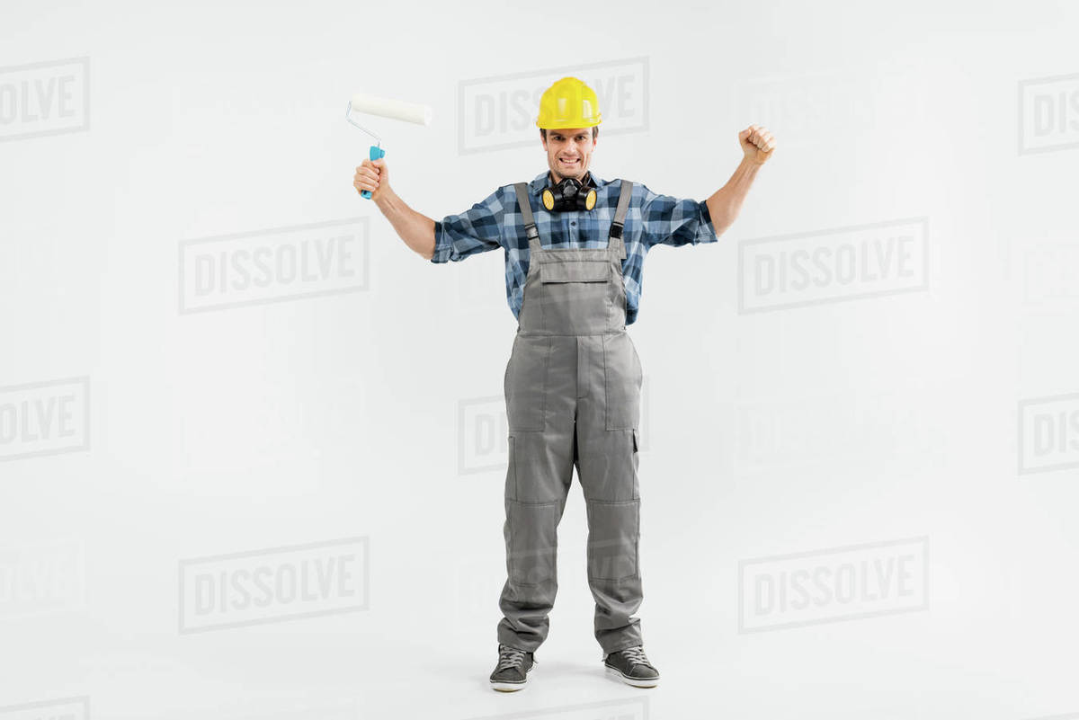 Full length portrait of cheerful professional male construction worker ...