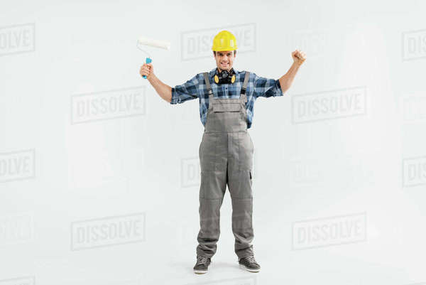 Full length portrait of cheerful professional male construction worker ...