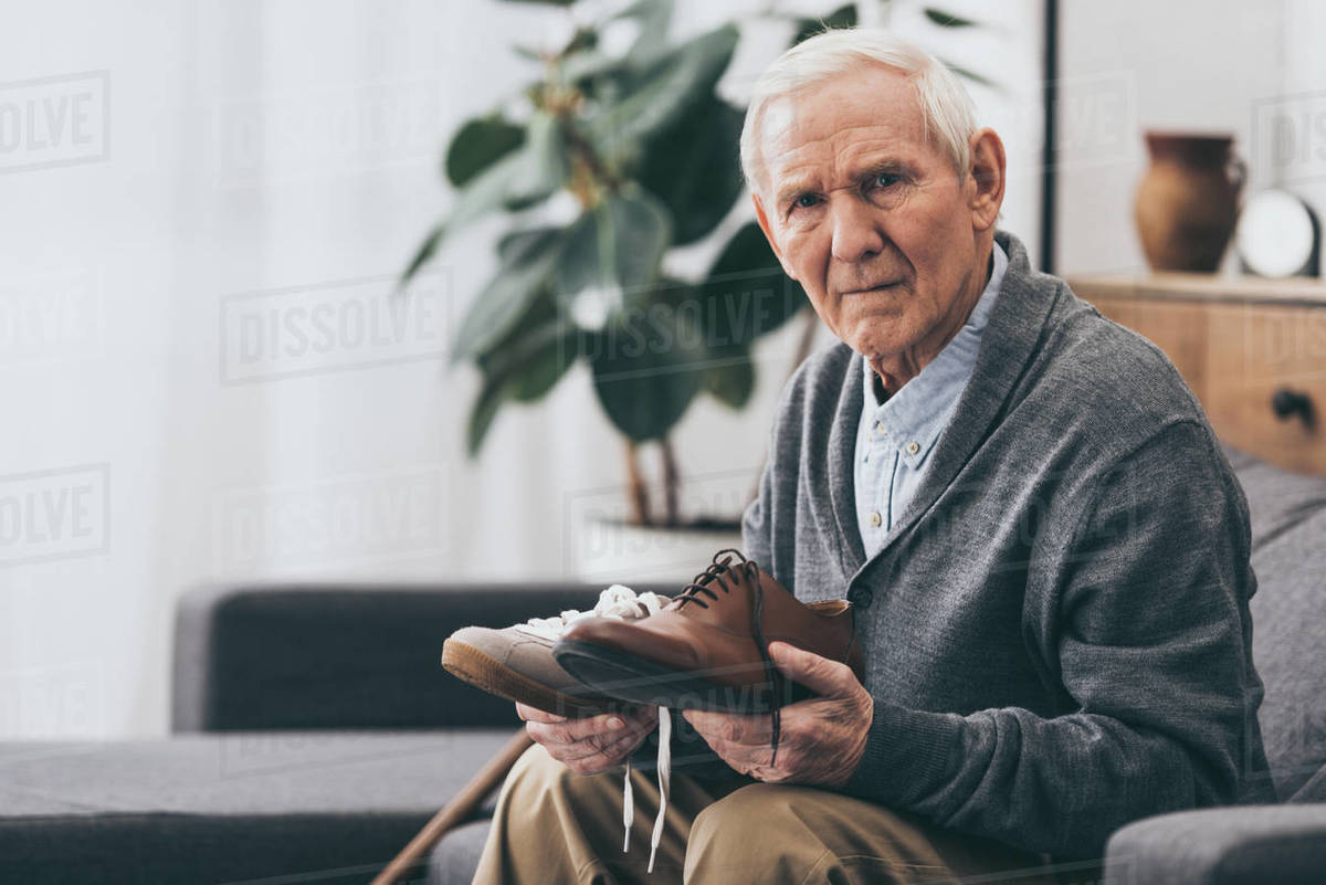 Senior man holding classic and modern shoes in hands - Royalty-free ...