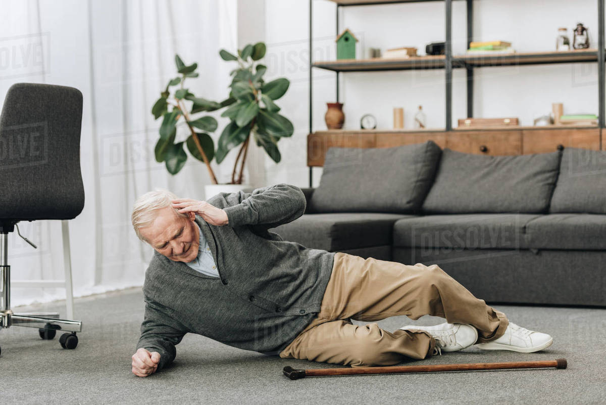 Old men fell down on floor and touching head - Stock Photo - Dissolve