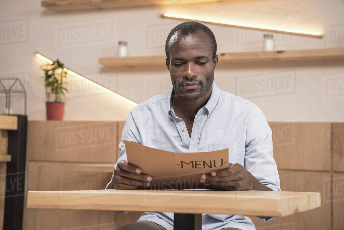 African American man in cafe looking at menu list - Royalty-free Stock ...