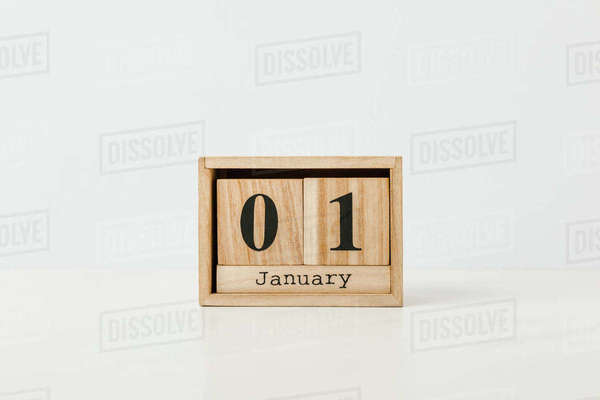Close-up view of wooden calendar with 01 January on white background ...