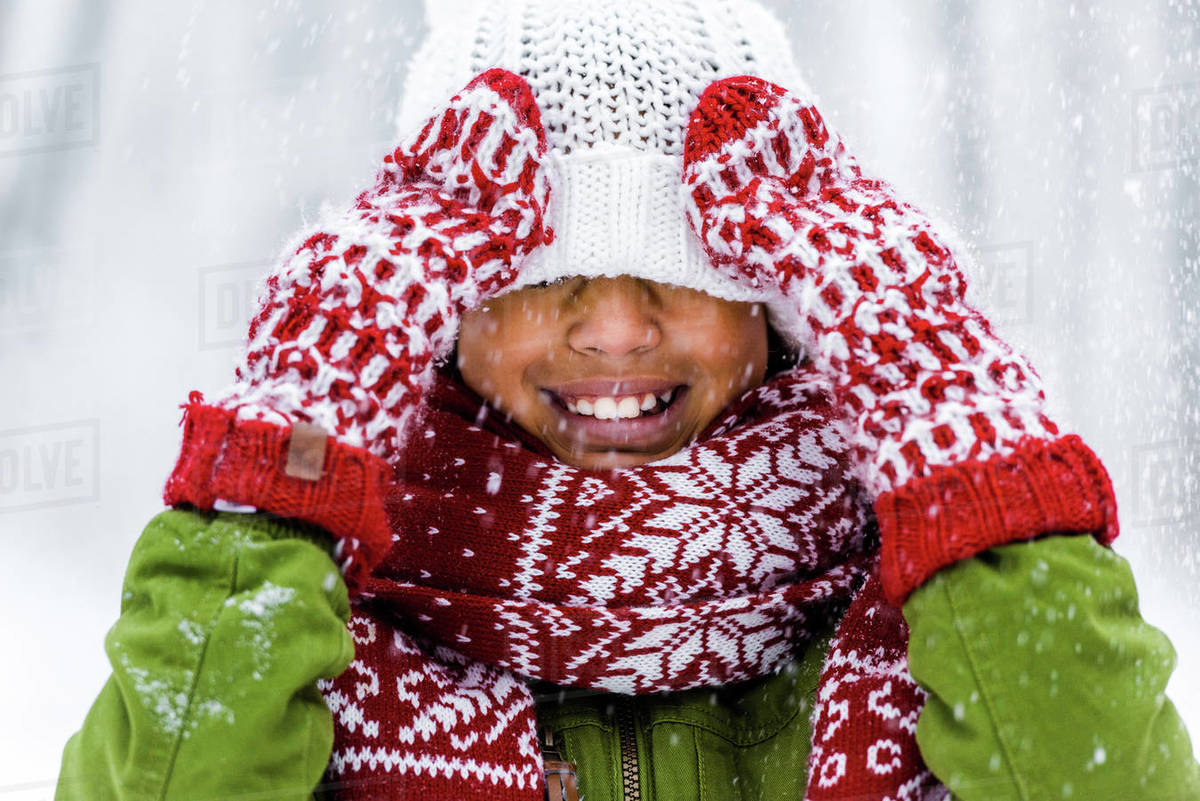 Cute African American child with knitted hat pulled over eyes smiling ...