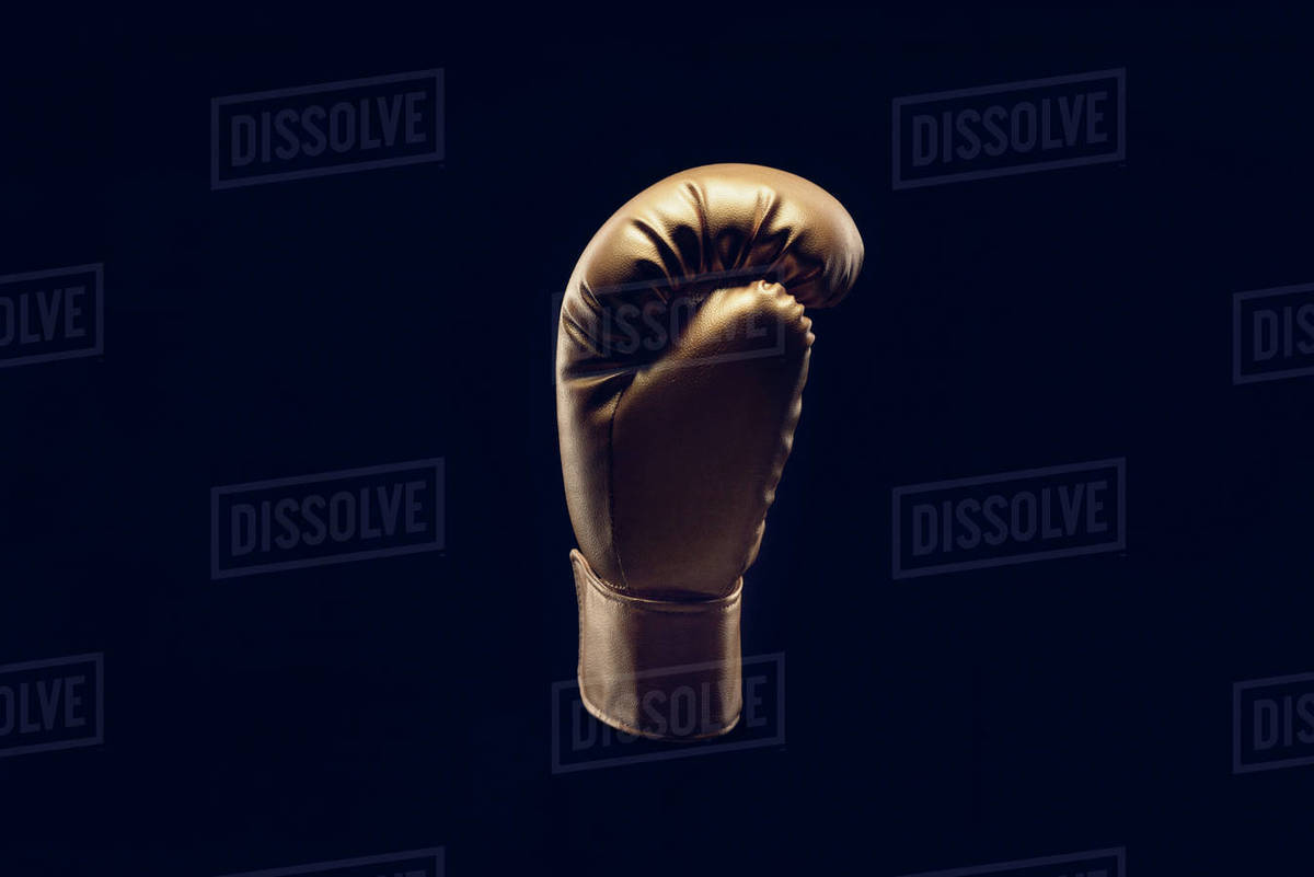 Close up view of golden boxing glove isolated on black - Royalty-free ...