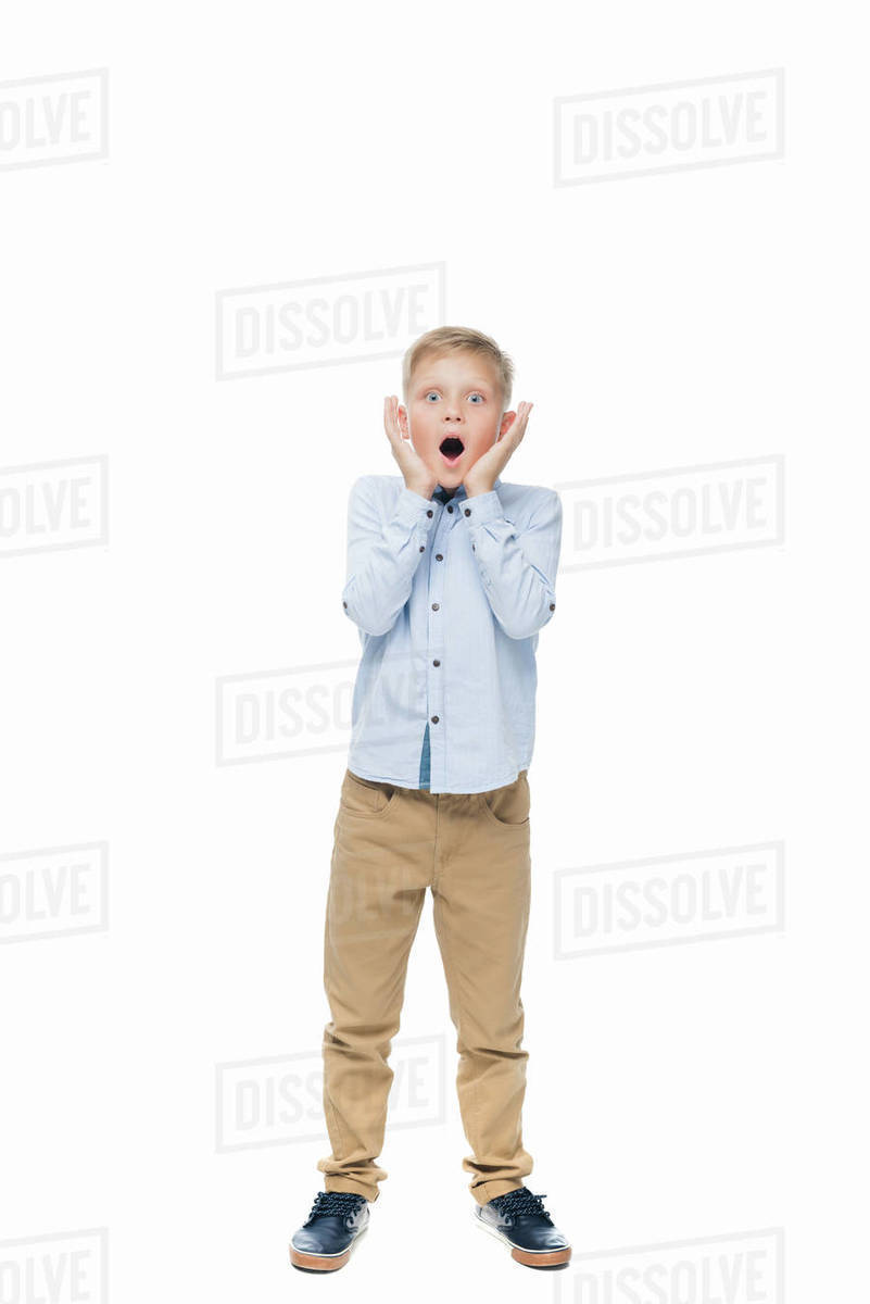 shocked caucasian little boy with hands on cheeks looking at camera ...