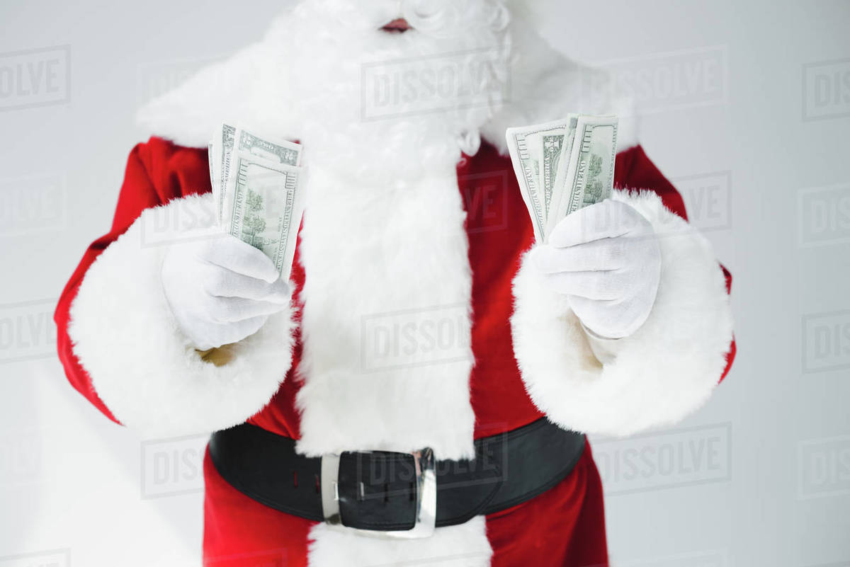 cropped shot of santa claus holding dollar banknotes isolated on white ...