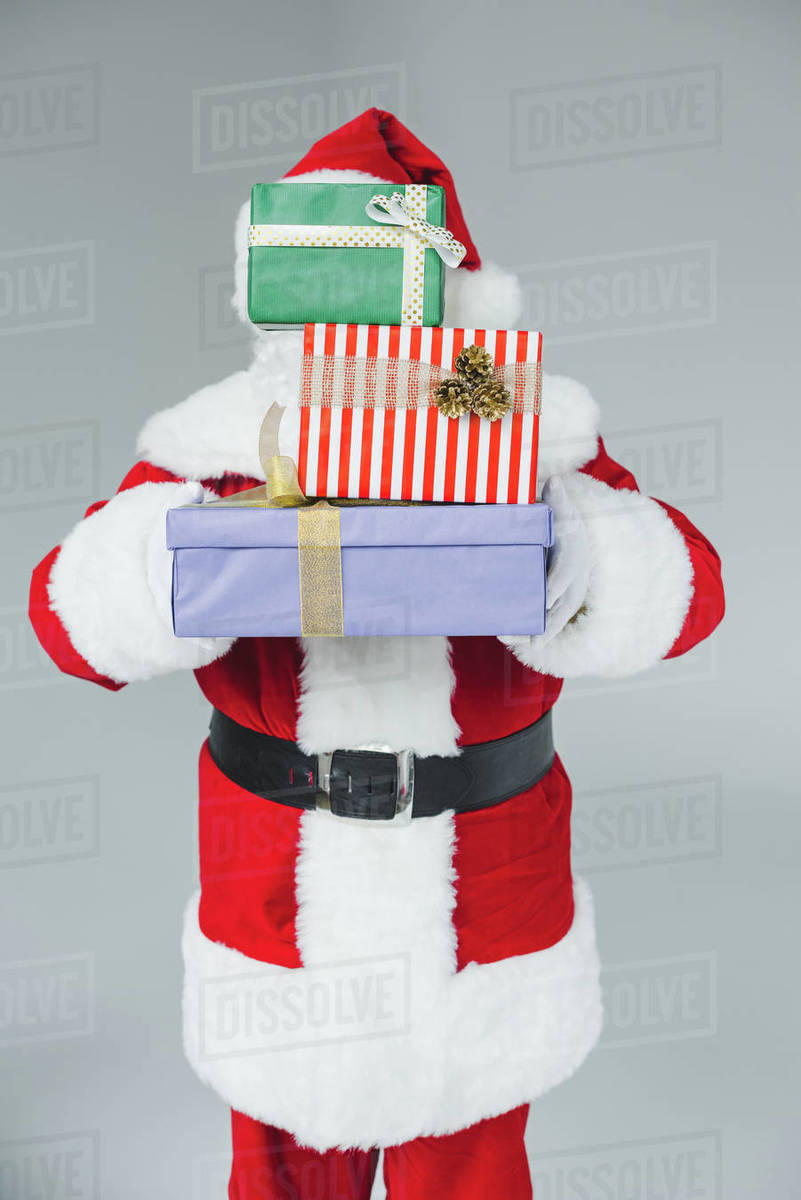 santa claus in costume holding various presents isolated on white ...