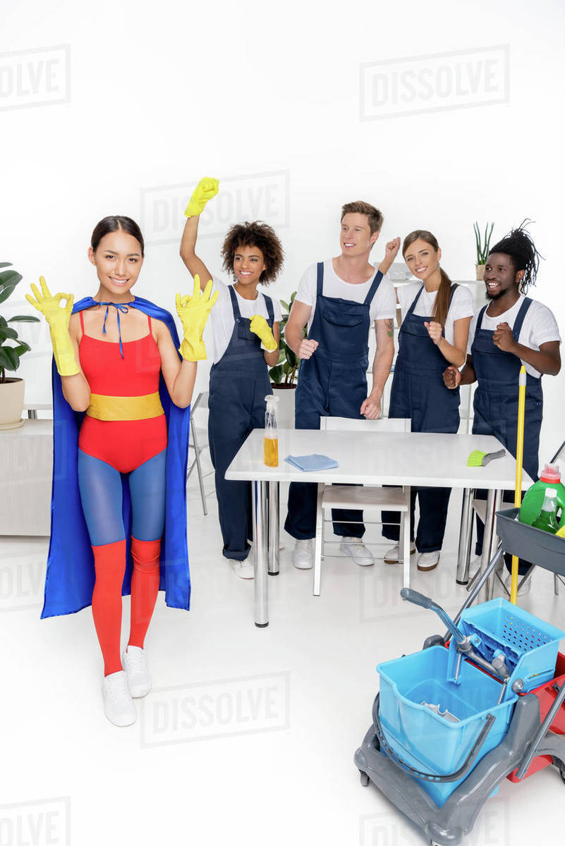 happy multiethnic group of professional cleaners working together while ...