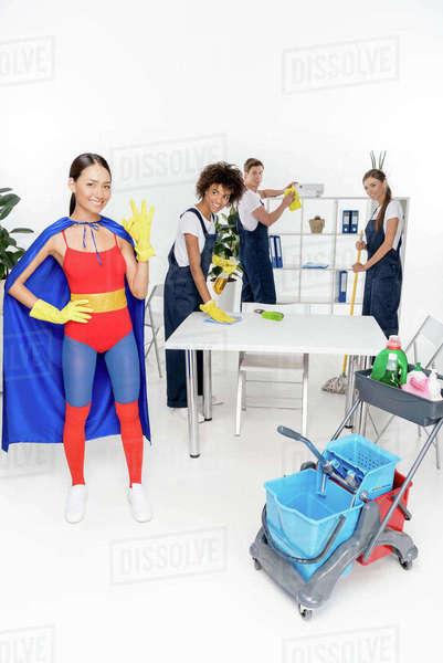 multiethnic group of professional cleaners working together while girl ...