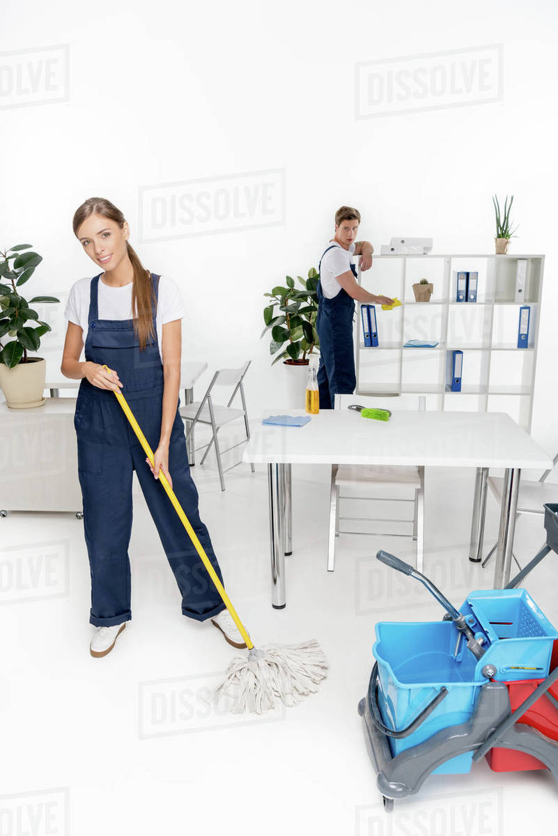 professional young male and female cleaners working together - Royalty ...