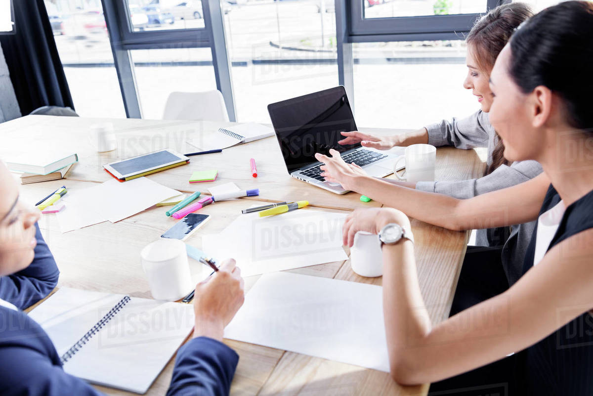 cropped shot of young multiethnic businesswomen working together in ...